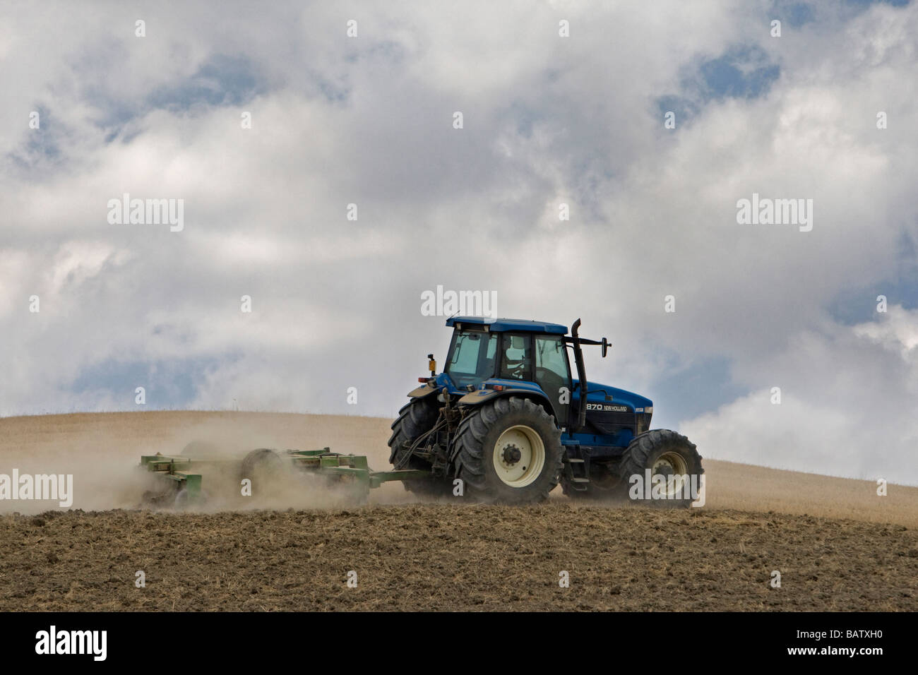 Italy, Tuscany, Tractor driving across field Stock Photo - Alamy