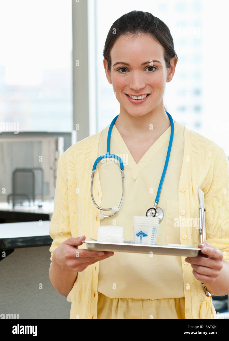 Portrait of female nurse with clipboard Stock Photo - Alamy