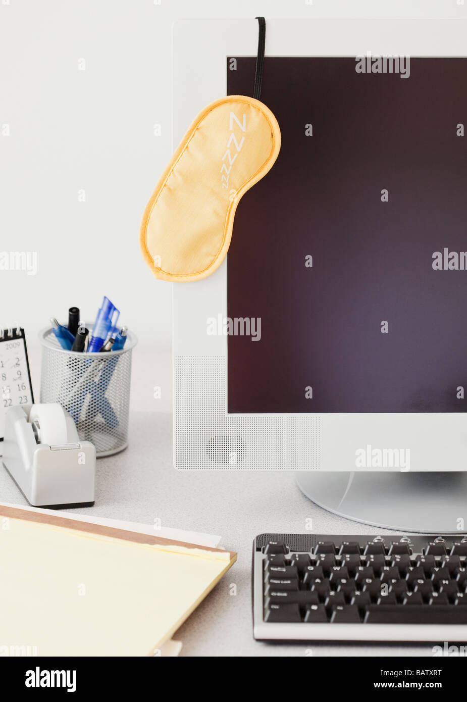 Eye mask hanging on computer monitor Stock Photo - Alamy