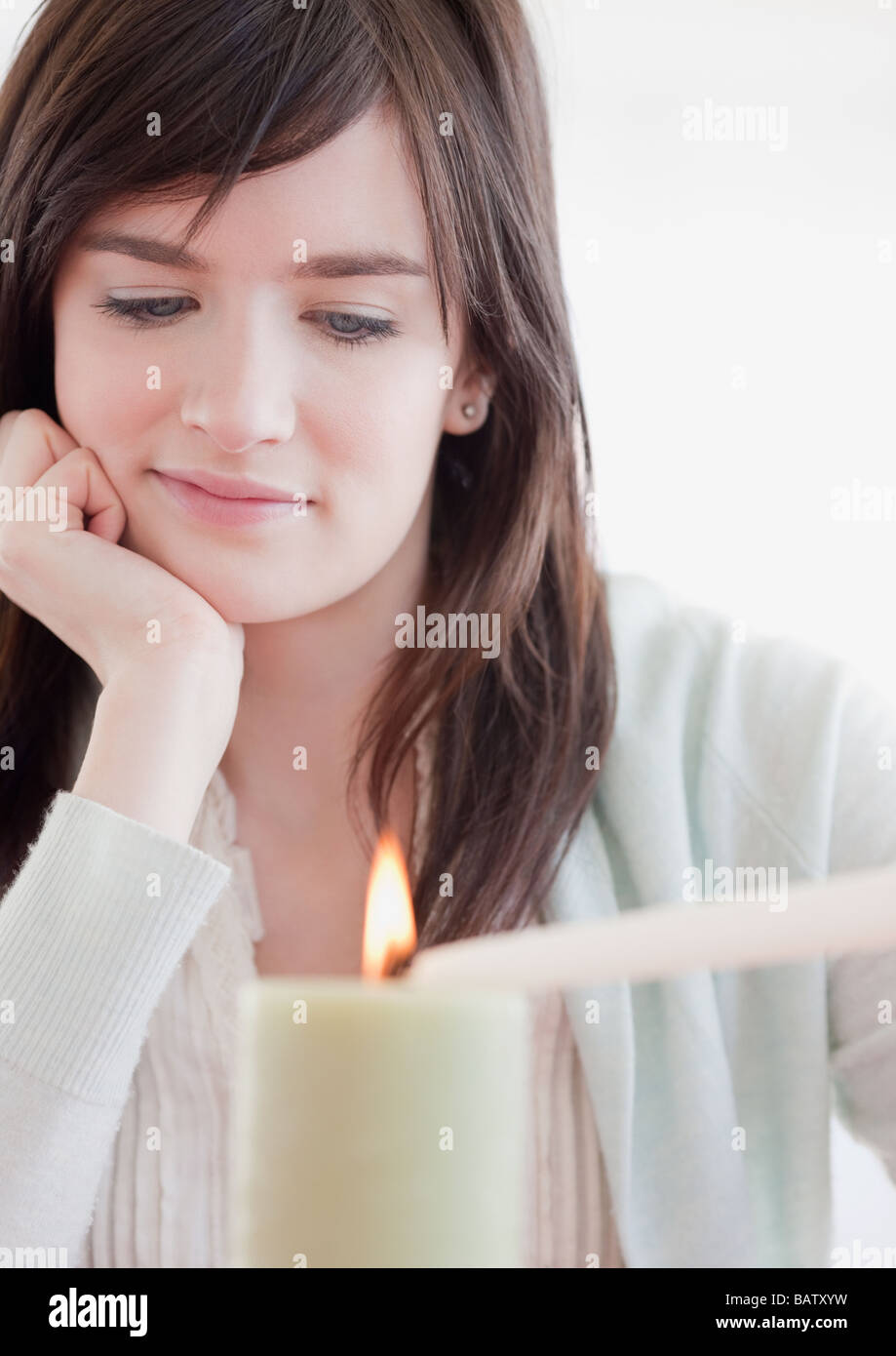 Young woman lighting candle Stock Photo - Alamy