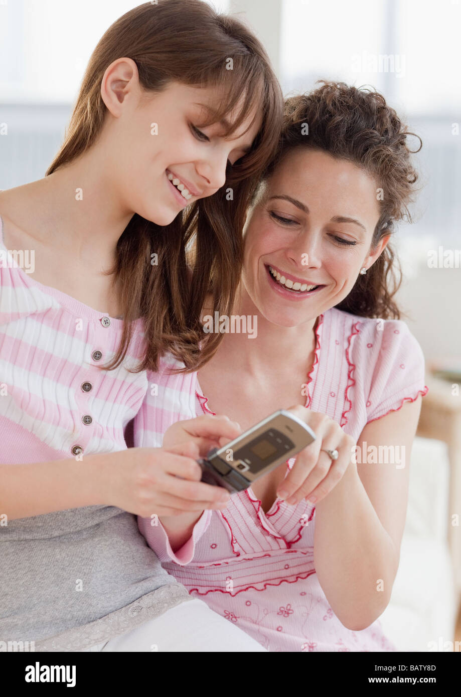 Daughter (10-11 years) teaching mother how to send text messages Stock ...