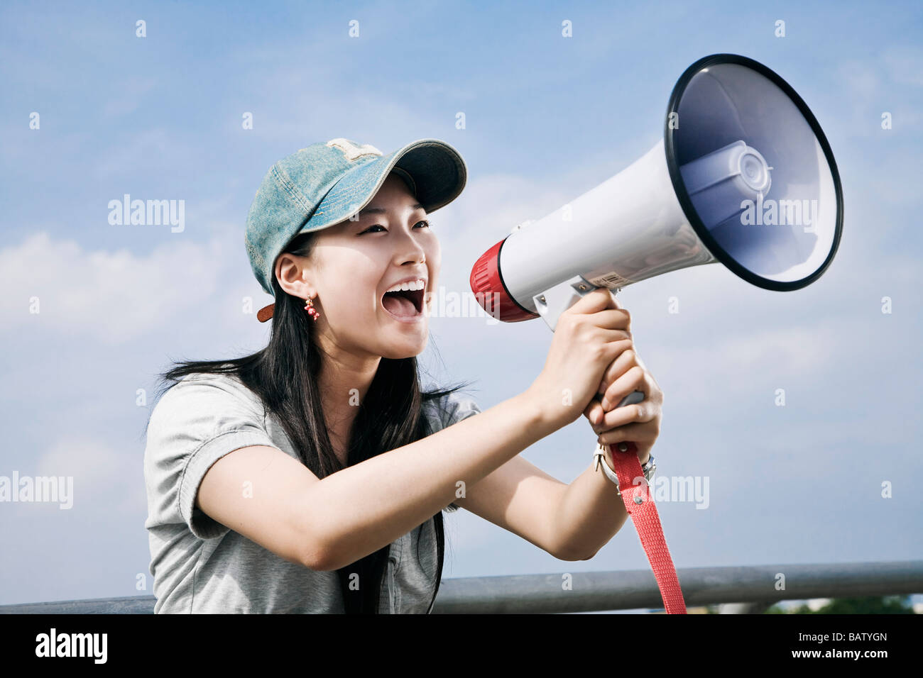 portrait of young japanese woman shouting through megaphone Stock Photo ...