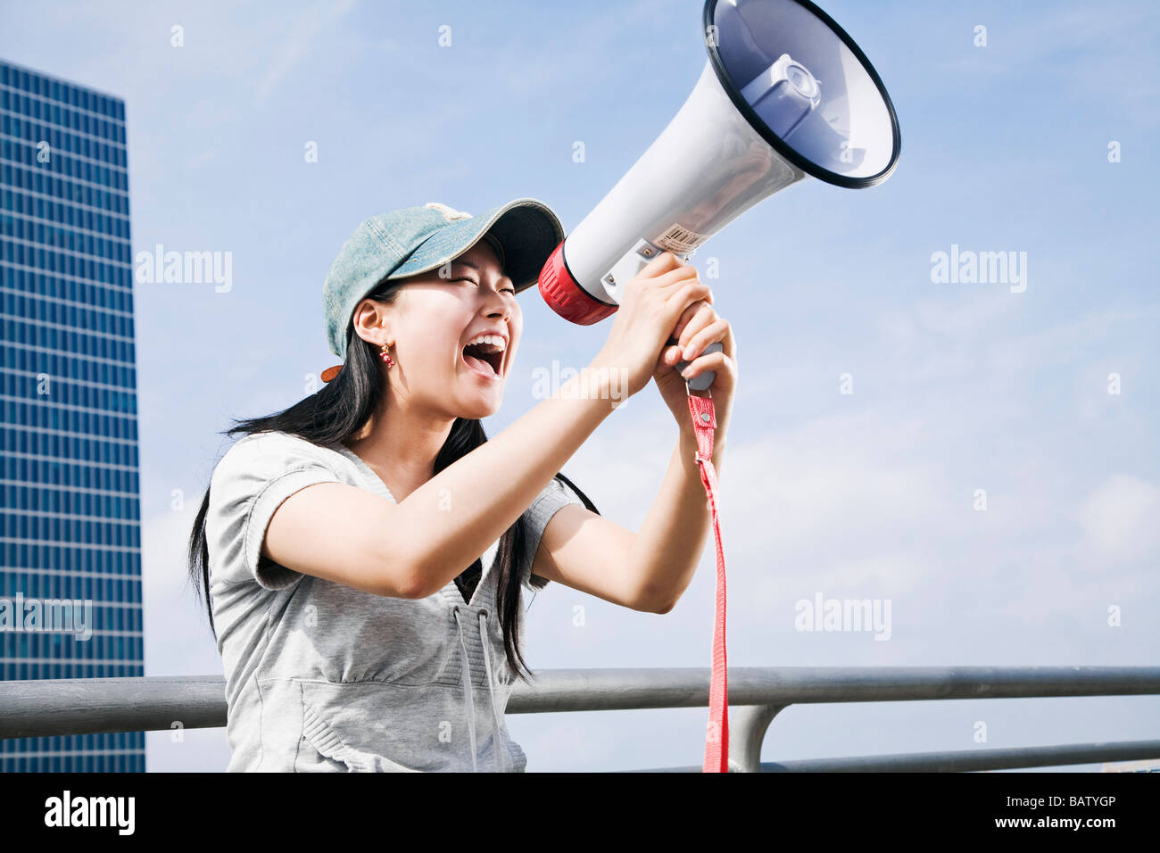 portrait of young japanese woman shouting through megaphone Stock Photo ...