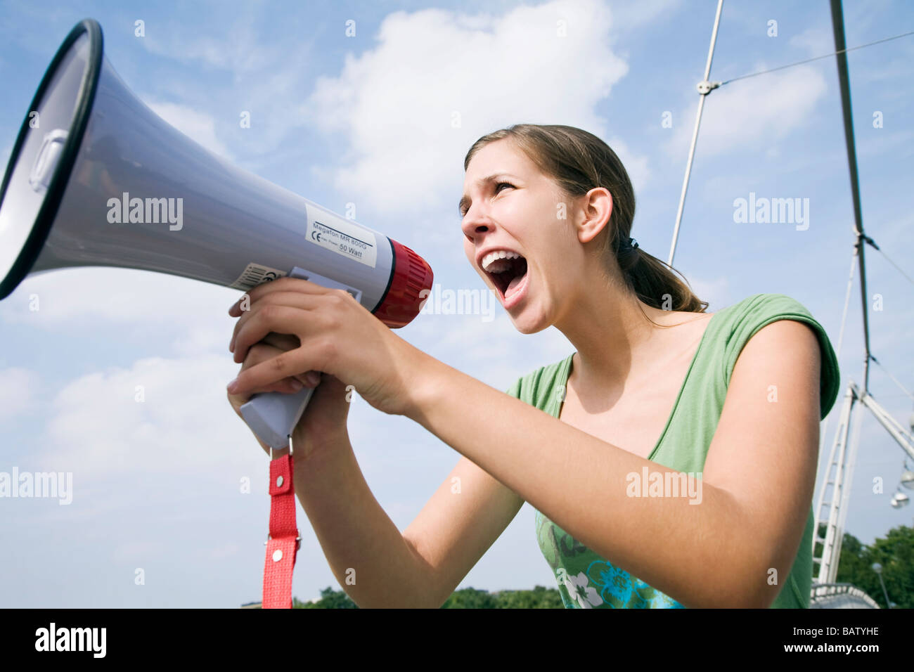 portrait of young woman shouting through megaphone Stock Photo - Alamy