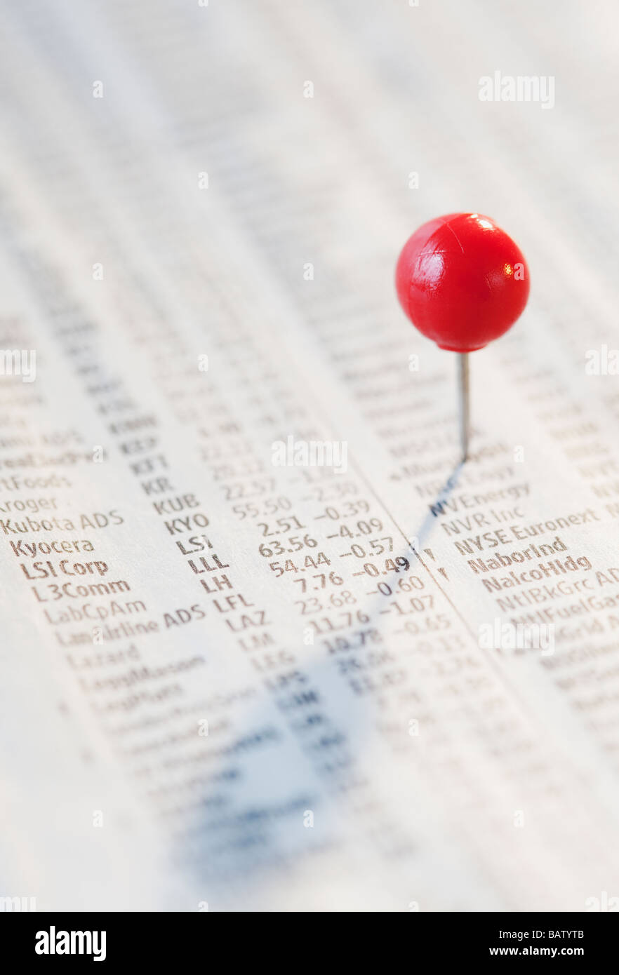 Close-up of pin on stock market newspaper Stock Photo - Alamy