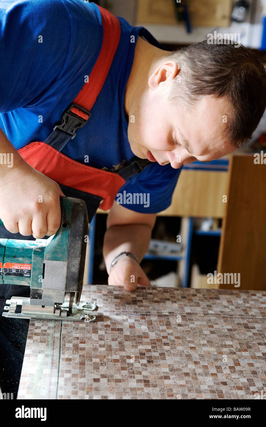 craftsman cutting wood with jigsaw Stock Photo - Alamy