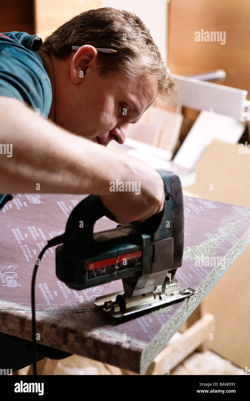 craftsman cutting wood with jigsaw Stock Photo - Alamy