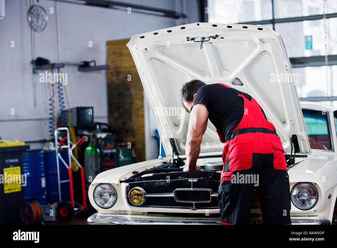 rear view of mechanic repairing car engine Stock Photo - Alamy