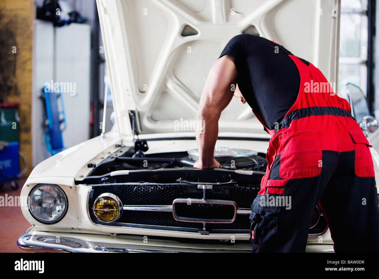 rear view of mechanic repairing car engine Stock Photo - Alamy