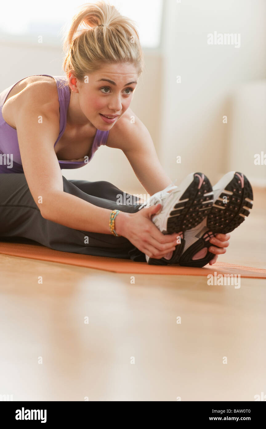 Young woman performing stretching exercises Stock Photo - Alamy