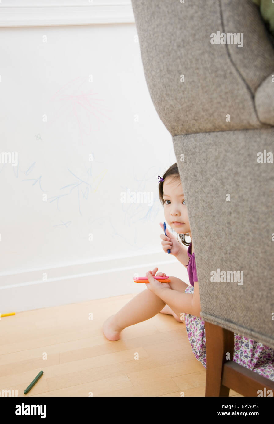 Girl hiding behind chair hi-res stock photography and images - Alamy