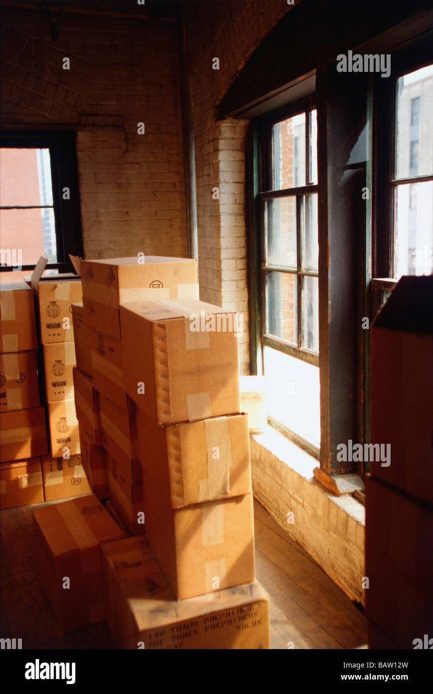 Stacked cardboard boxed in house Stock Photo - Alamy