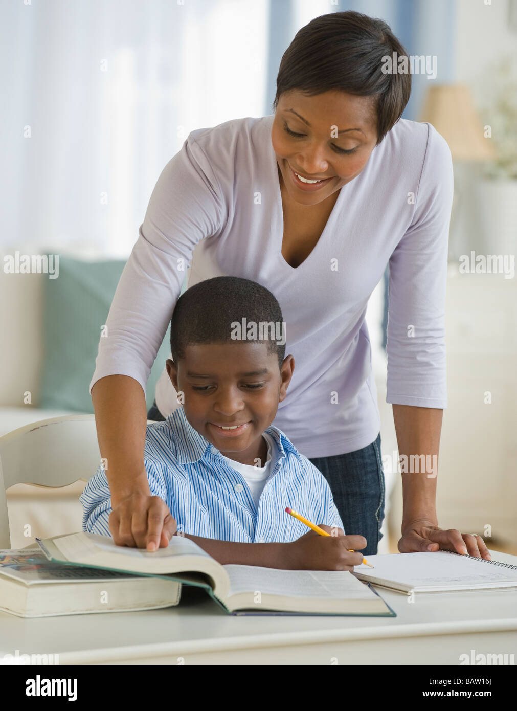 African mother helping son with homework Stock Photo - Alamy