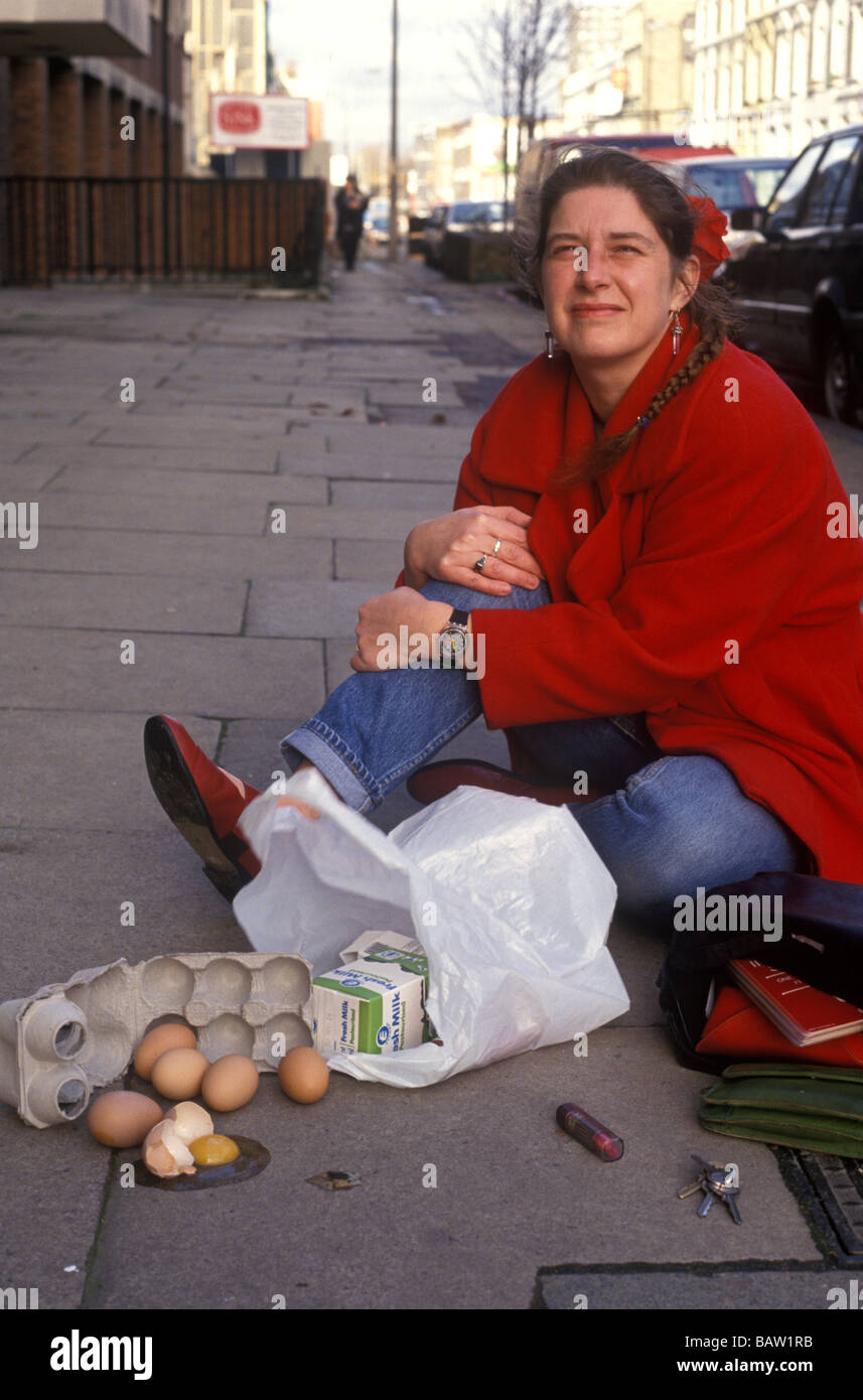 woman who has fallen over in the street and hurt herself and dropped ...