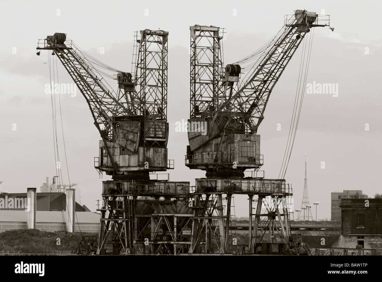 Two riverside cranes used for unloading and loading barges boats etc ...