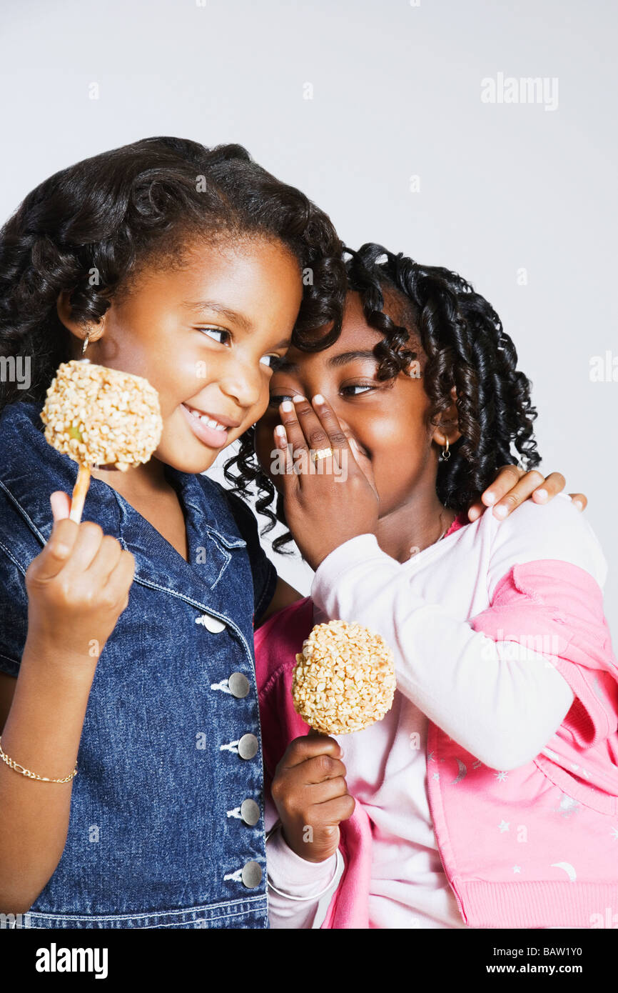 Two girls sharing secrets together hi-res stock photography and images ...
