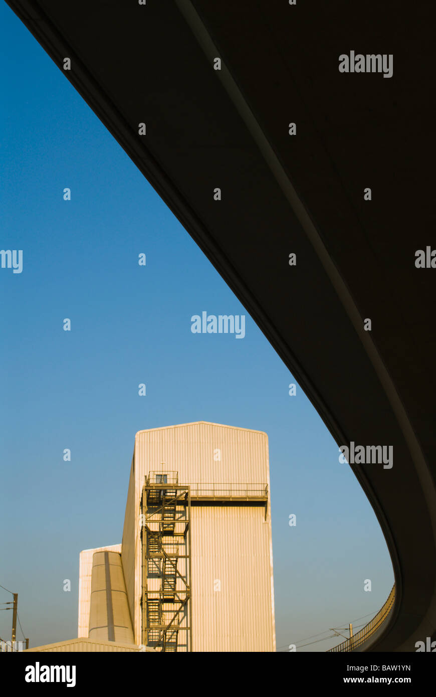Industrial building shot from underneath a motorway overpass Stock ...