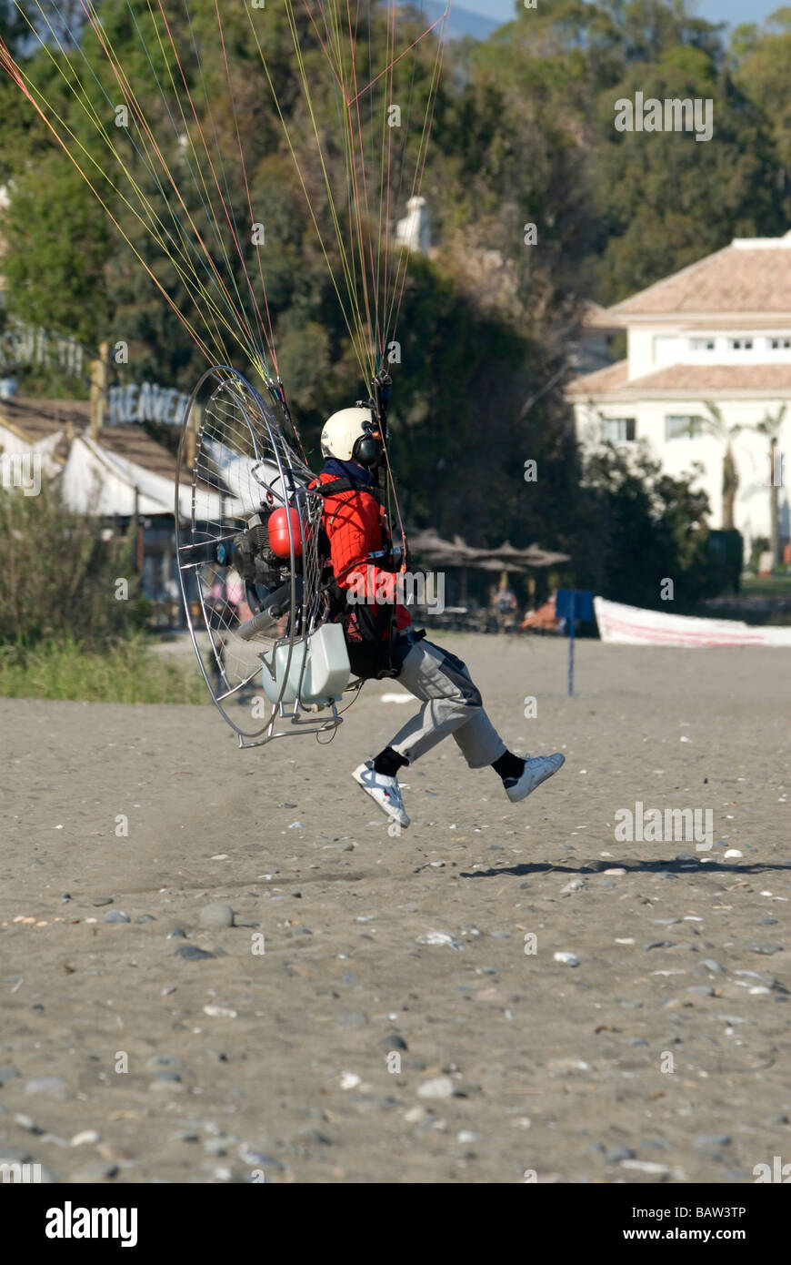 Motor powered para glider pilot launching from beach Stock Photo - Alamy