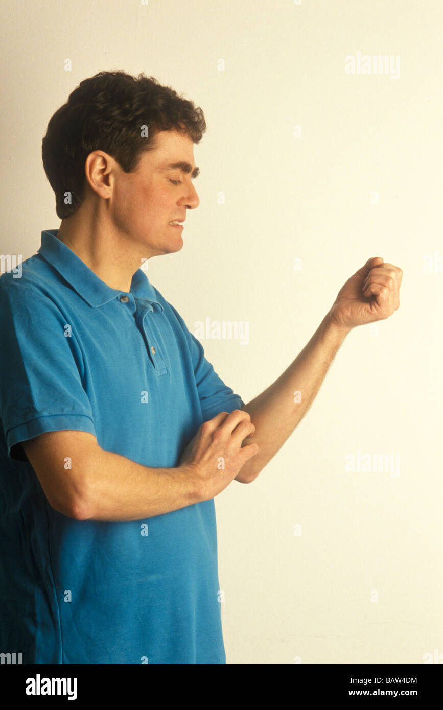 man scratching his arm Stock Photo - Alamy