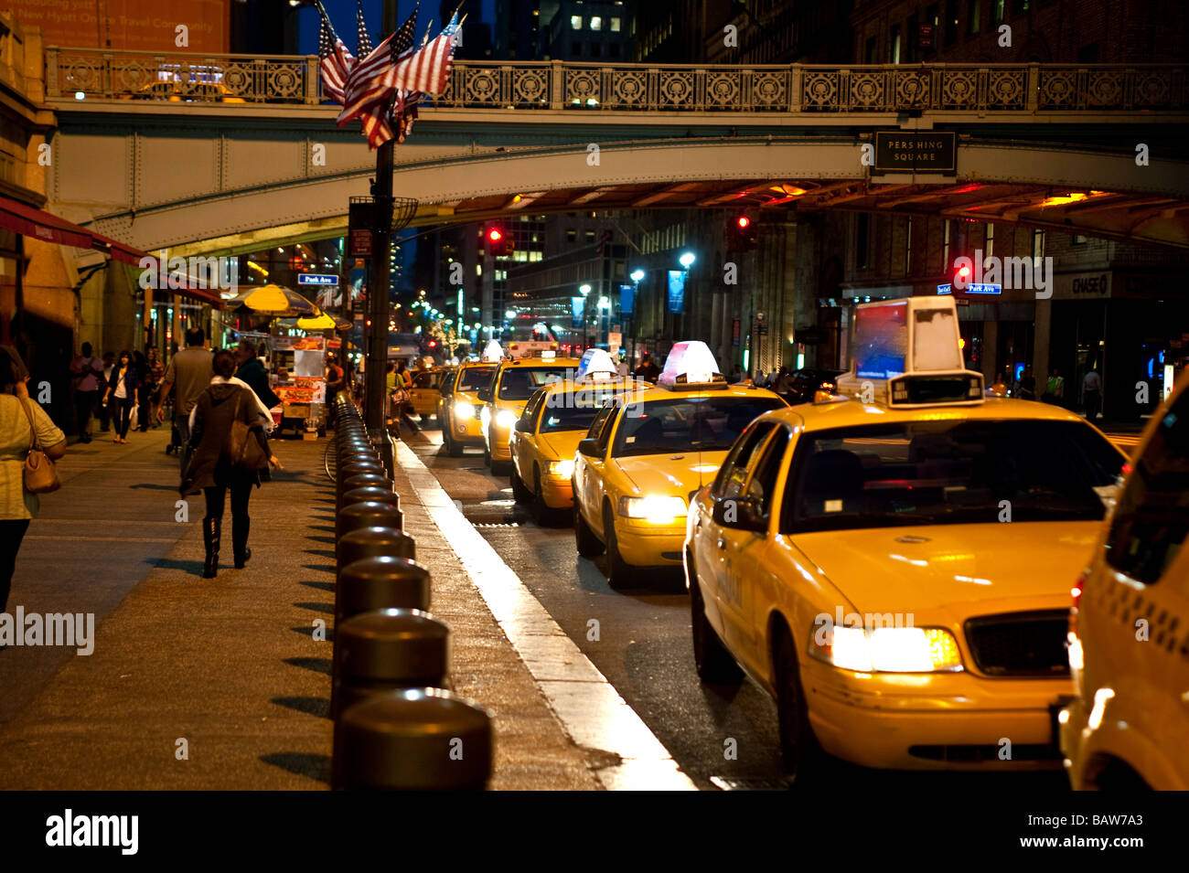Taxis lined up at a curb at night waiting for customers Stock Photo - Alamy