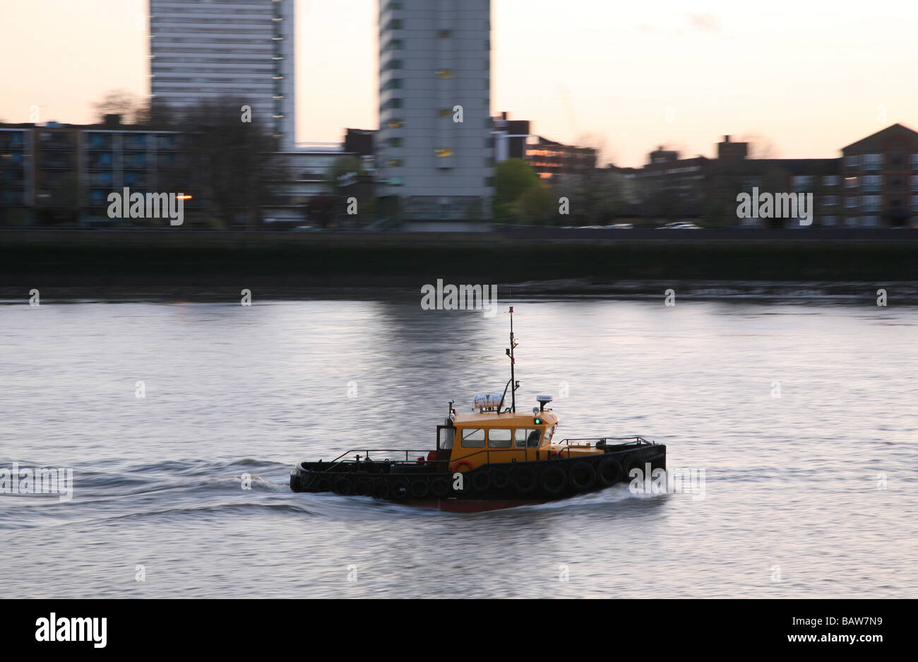 A boat making it's way upstream on the River Thames London Stock Photo ...