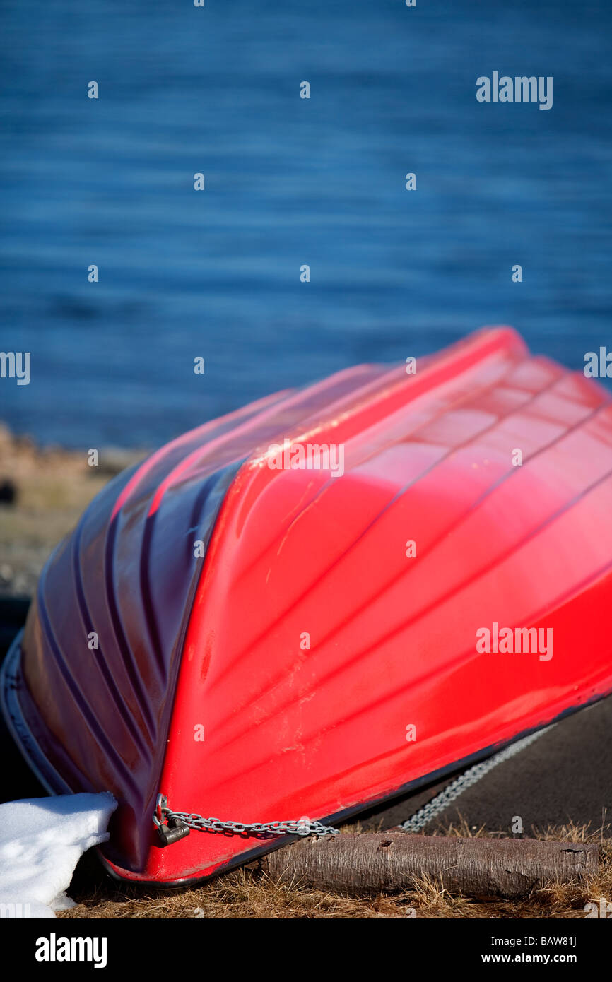 Upturned moored fiberglass red rowboat ( skiff / dinghy Stock Photo - Alamy