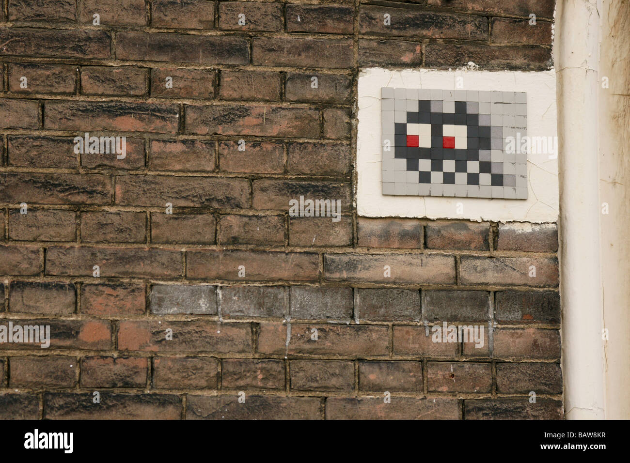 Pixelated alien strange creature wall painting on building facade ...