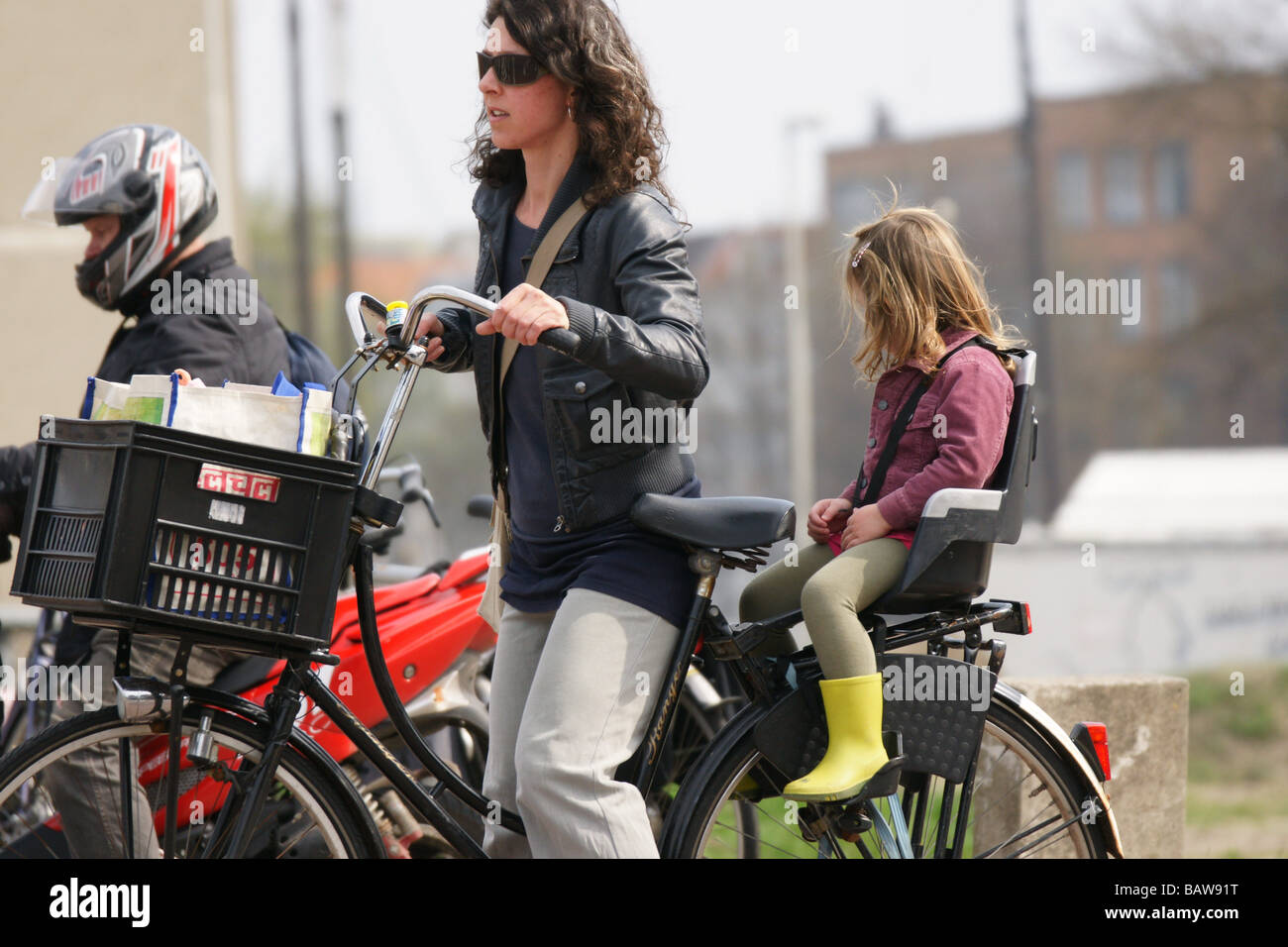 Woman monther carrying child on bicycle dutch transport street ...