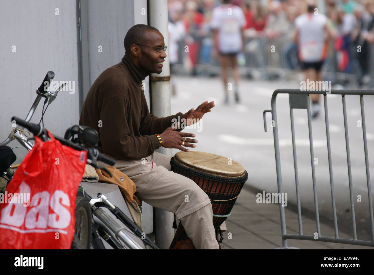Drummer man musician black drumming sitting at Rotterdam City Street ...