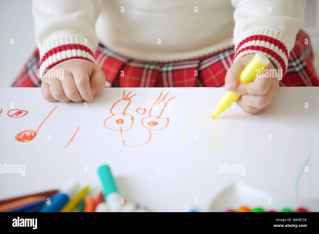 Girl drawing on paper Stock Photo - Alamy