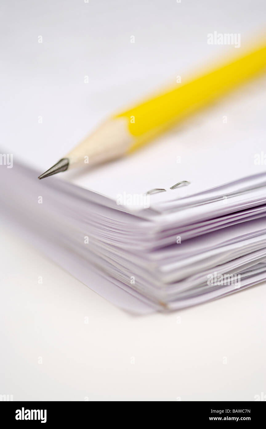Pencil and stack of paper Stock Photo - Alamy