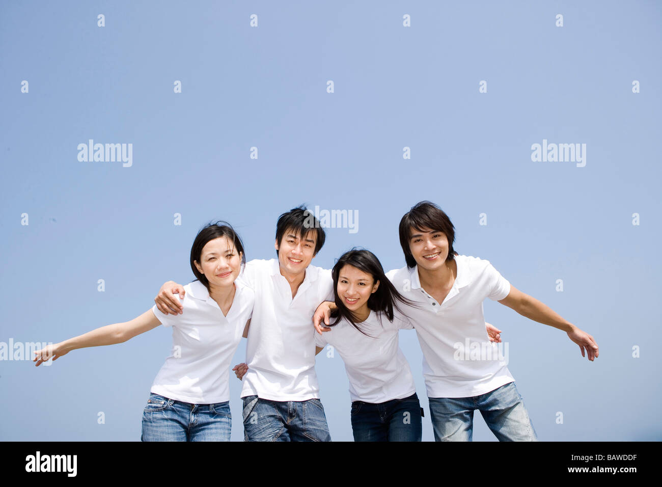Young adults with arms around each other front view Stock Photo - Alamy