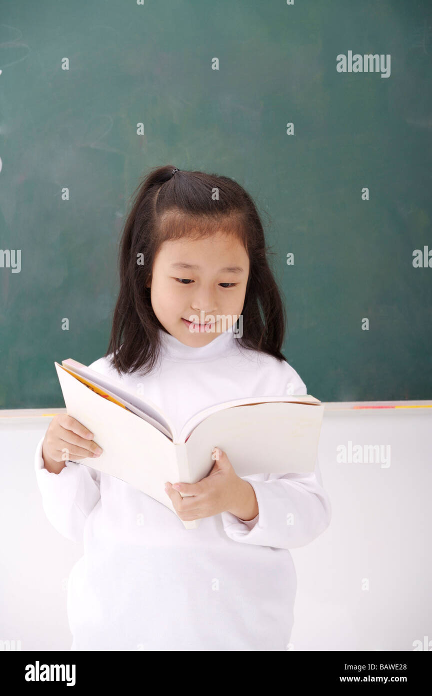 Girl reading to class front view Stock Photo - Alamy