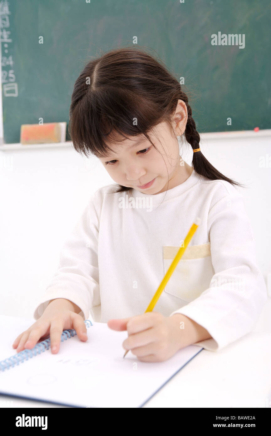 Girl taking notes in class Stock Photo - Alamy