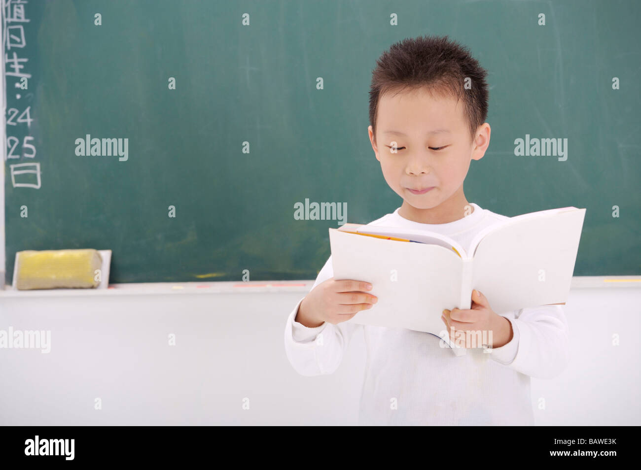 Boy reading to class front view Stock Photo - Alamy