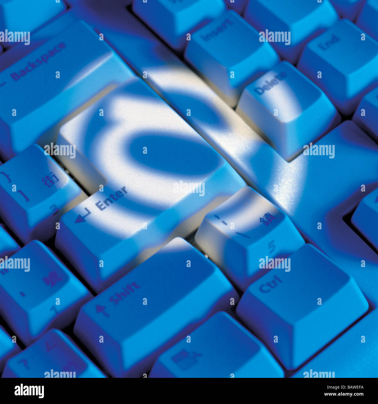 At symbol projected on computer keyboards Stock Photo - Alamy