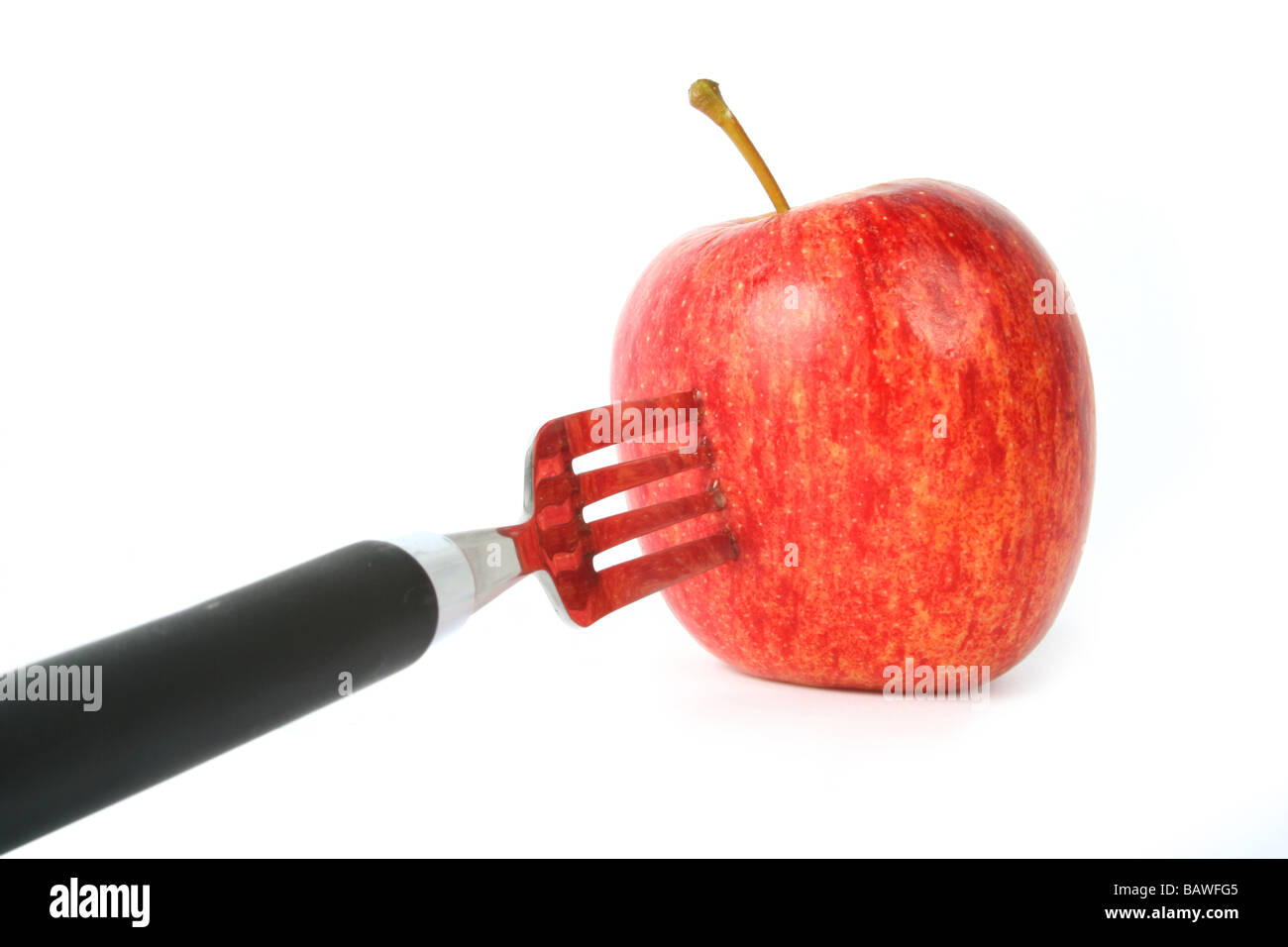 apple on fork - perspective Stock Photo - Alamy
