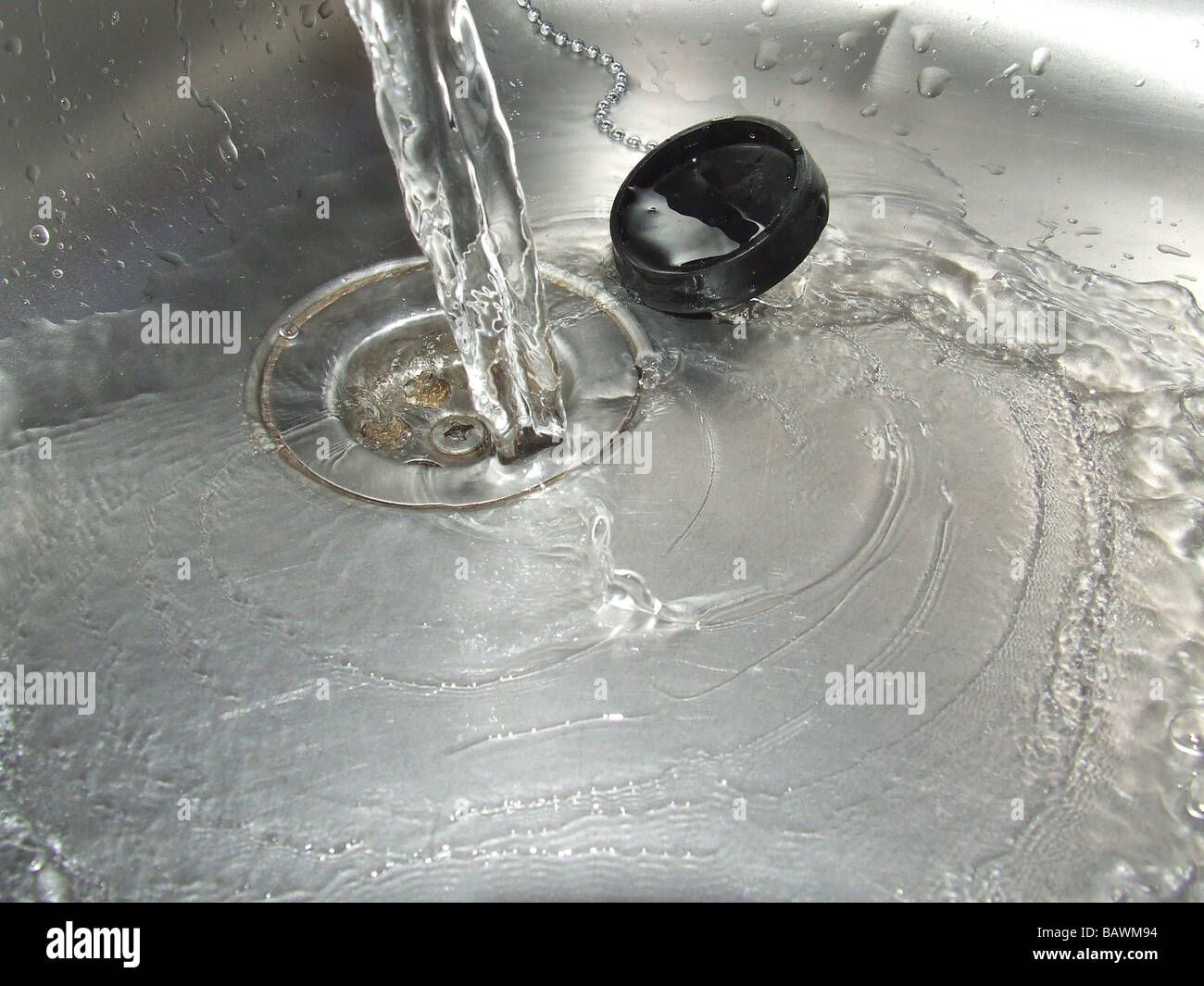 Water washing down a drain Stock Photo - Alamy