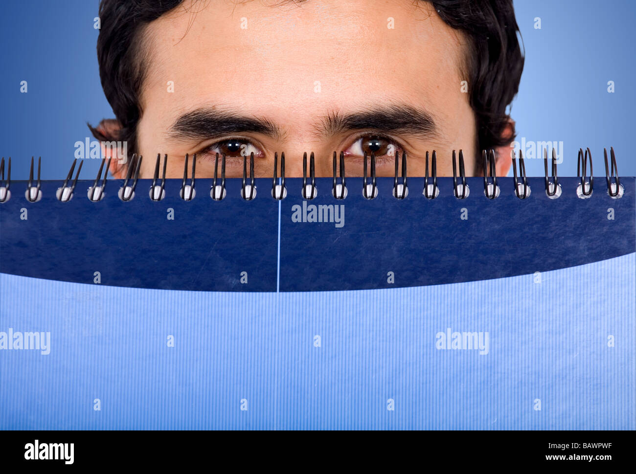 student peeping over a notebook Stock Photo - Alamy