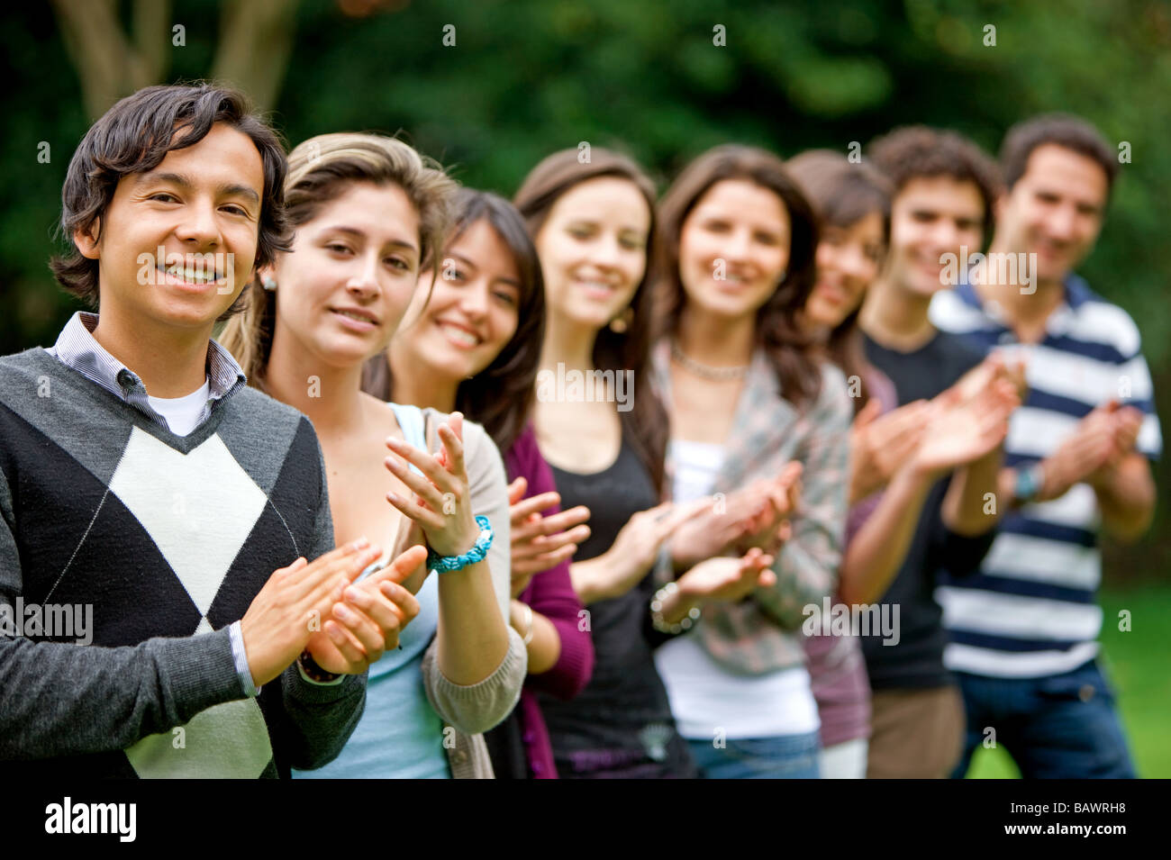 casual friends clapping in the park Stock Photo - Alamy