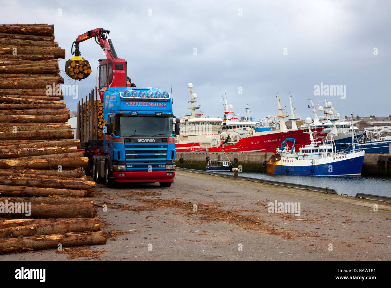 Scania Grab Hiab Loader haulage truck loading freight, Timber stacks ...