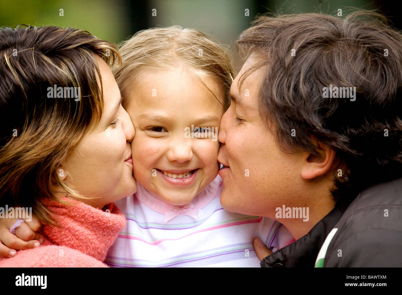 parents kissing daughter Stock Photo - Alamy