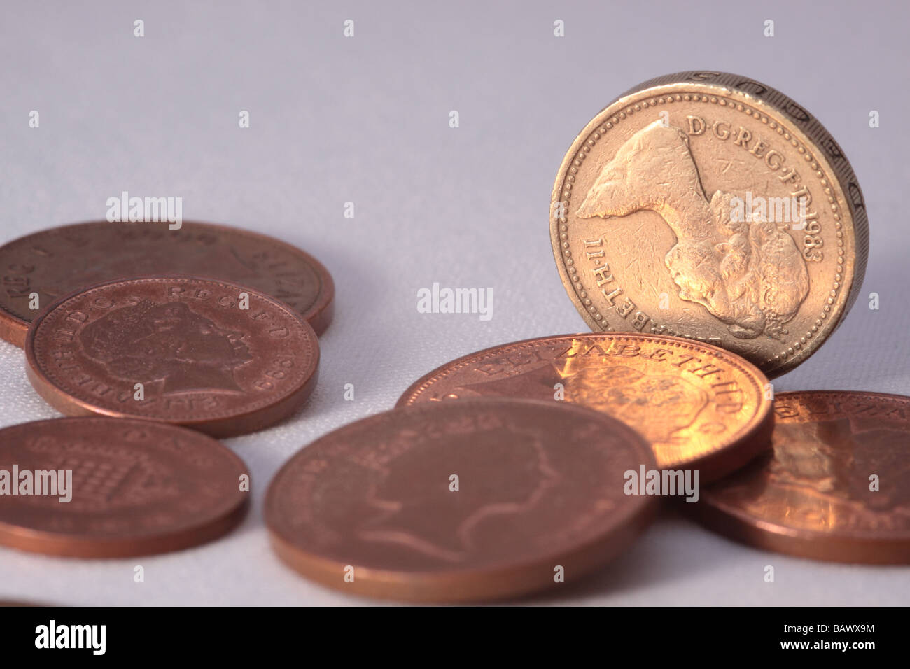 five pound note pound coin and assorted small change on a table Stock ...