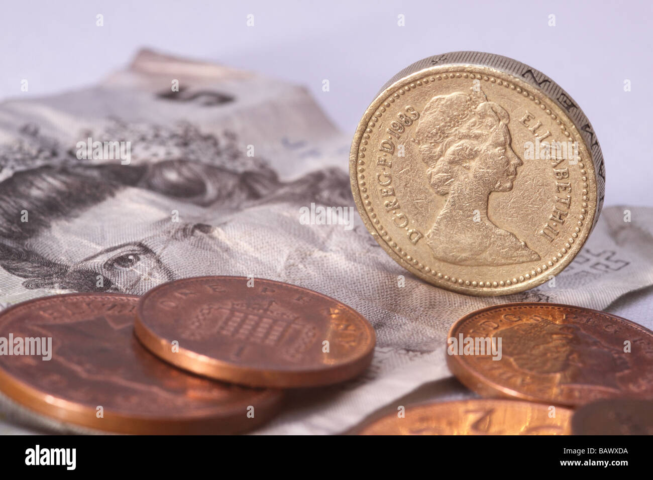 five pound note pound coin and assorted small change on a table Stock ...