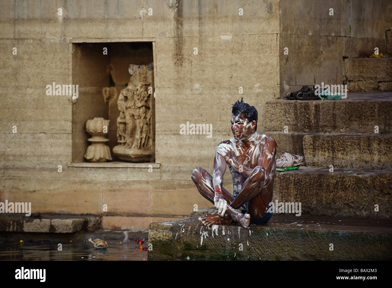 Man washing himself on the banks of Ganges river in Varanasi, India ...