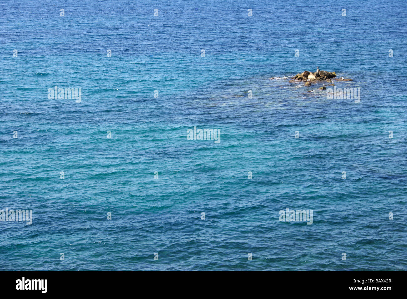 Blue sea & rock Stock Photo - Alamy