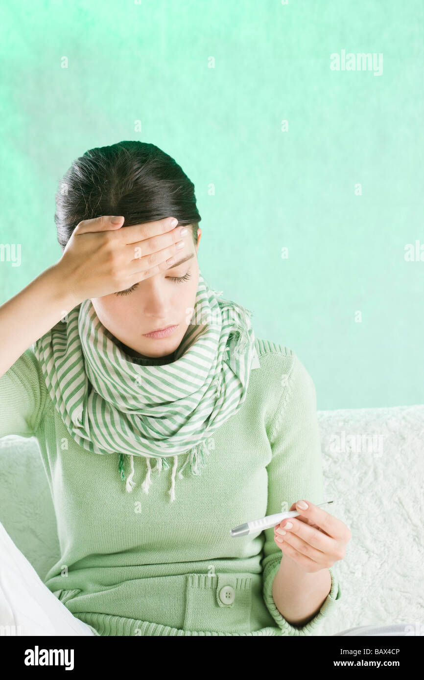 woman checking her body temperature Stock Photo - Alamy
