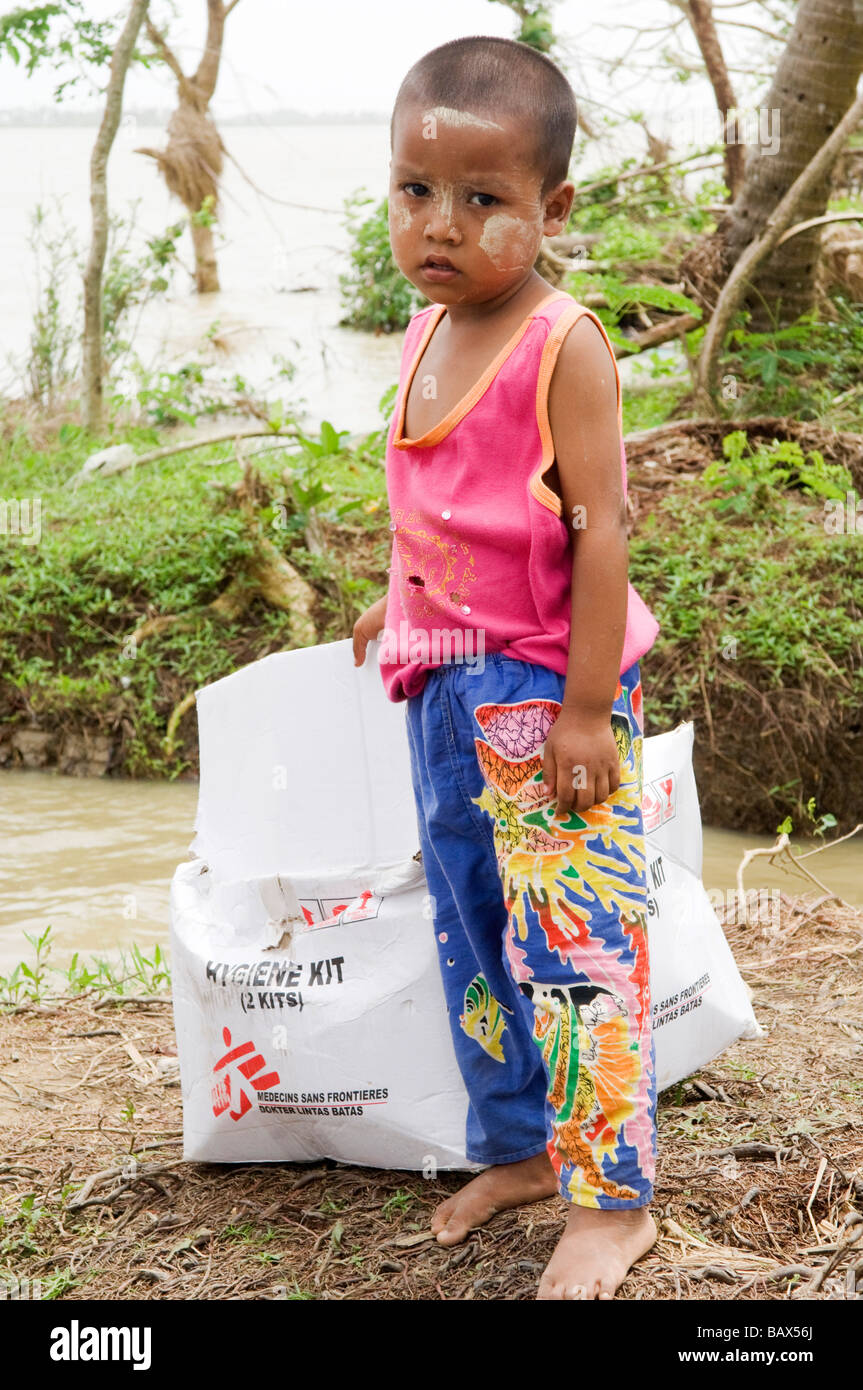 A child waits with relief items from MSF in Bogale after cyclone Nargis ...