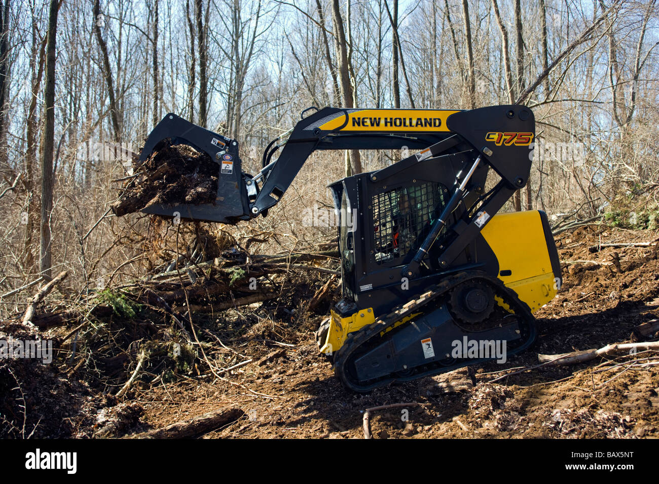 New Holland C 175 tracked skid loader clearing brush on a residential ...