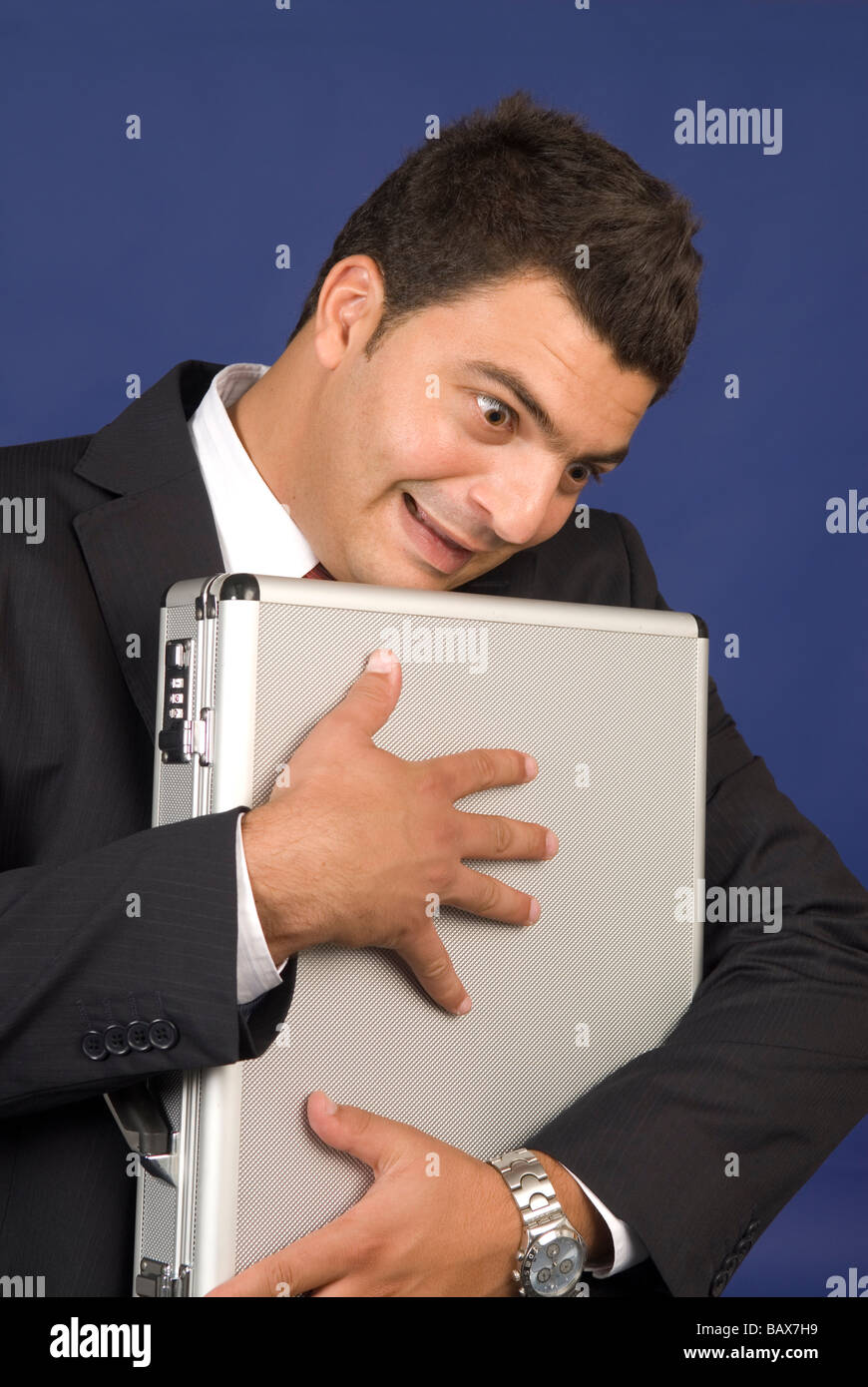 Business man hugging a briefcase Stock Photo - Alamy